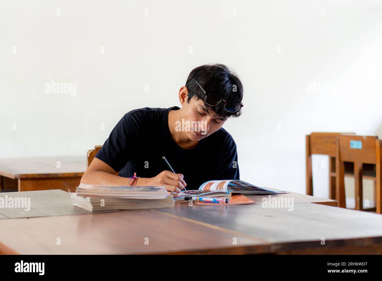 Overworked and tired high school student man studying feeling depressed ...