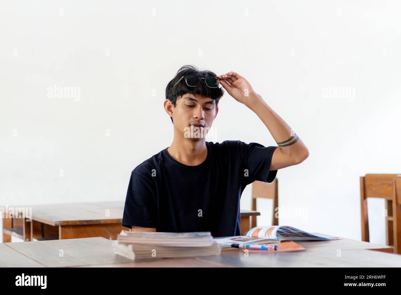 Overworked and tired high school student man studying feeling depressed ...