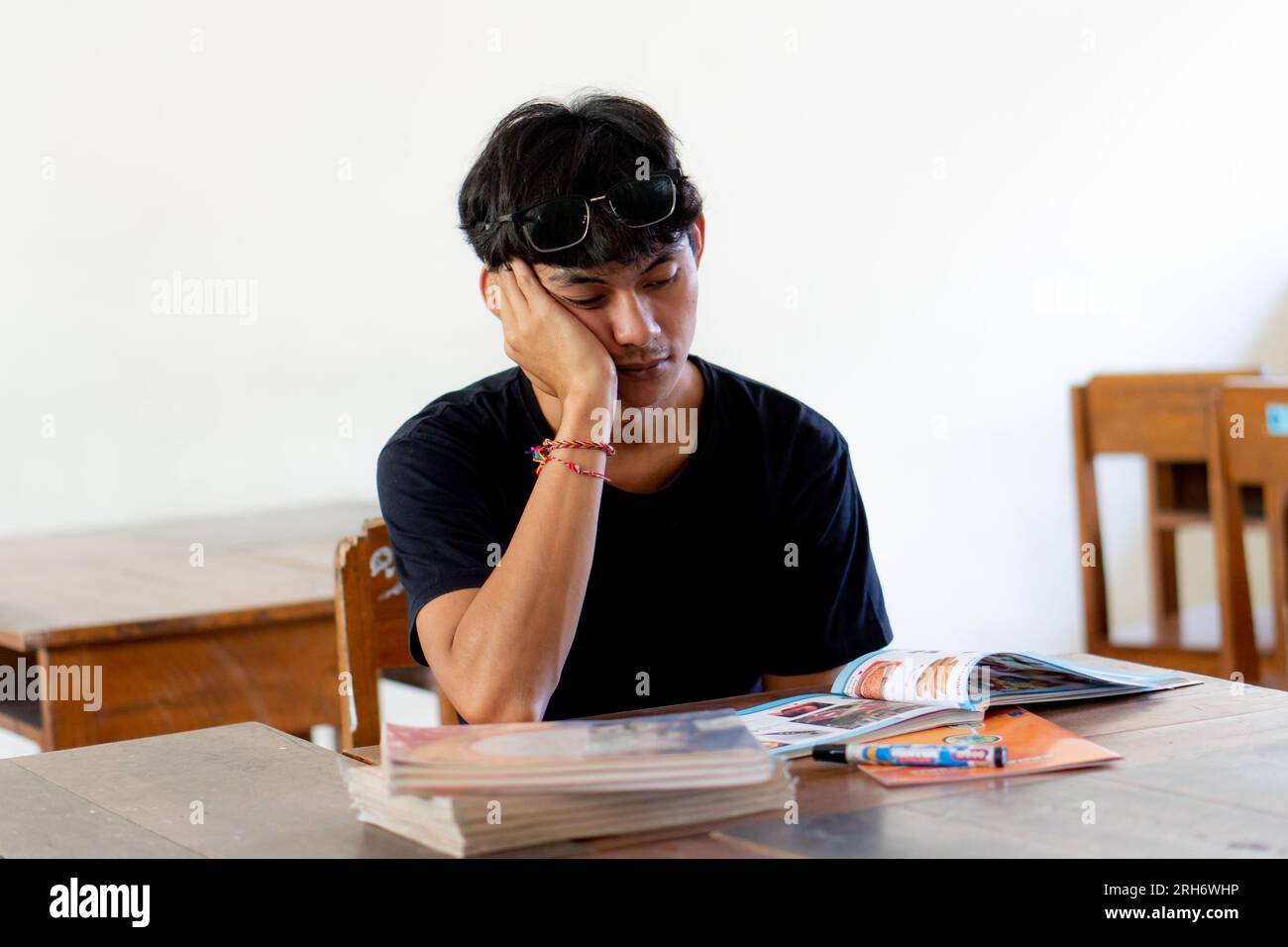 Overworked and tired high school student man studying feeling depressed ...