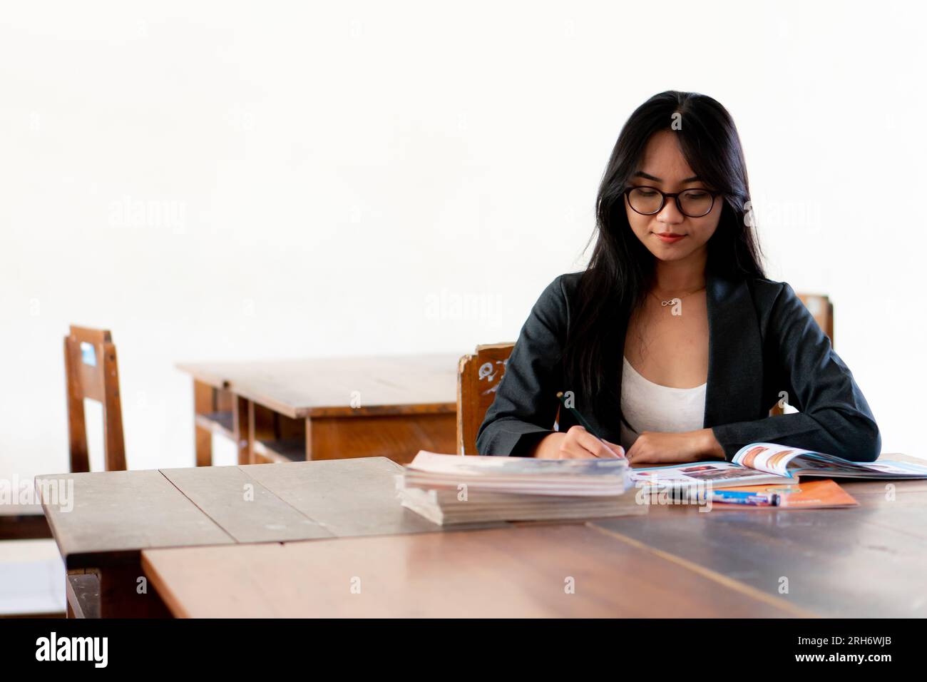 Young female student study in the school library. white background ...