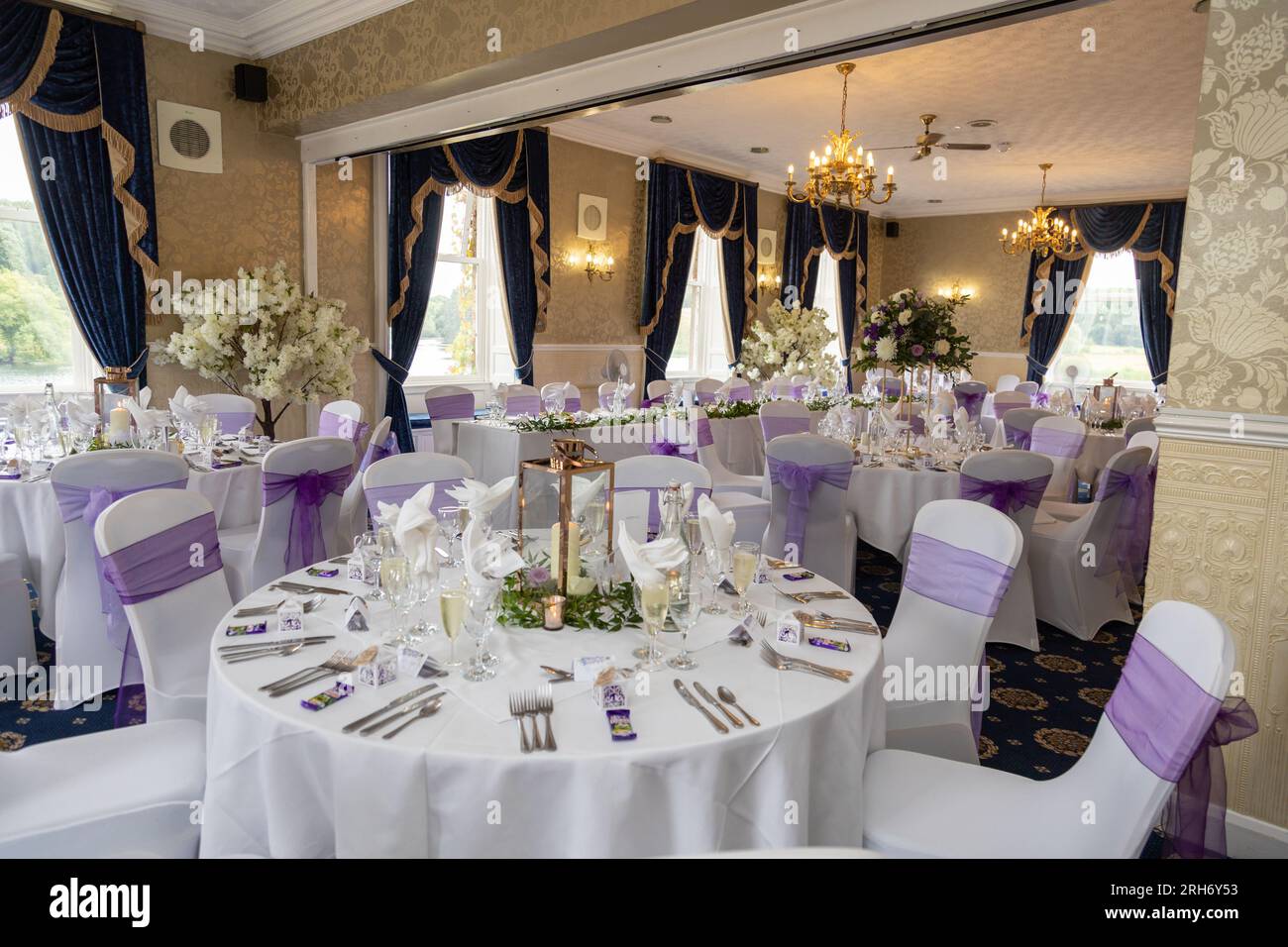 An empty wedding reception area set up with tables, ready for guests to ...