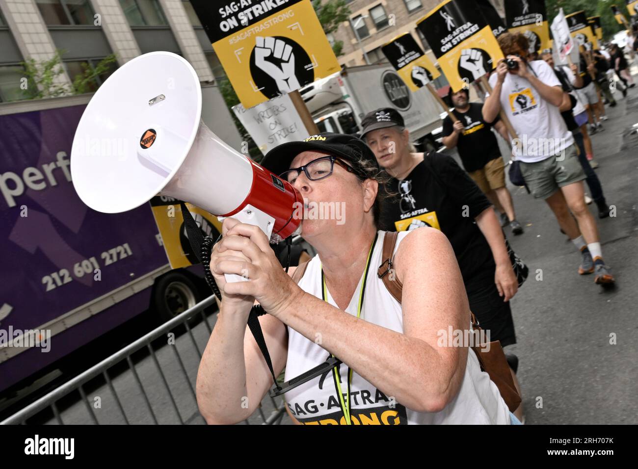 Picketers carry signs on the picket line outside Netflix on Monday, Aug ...
