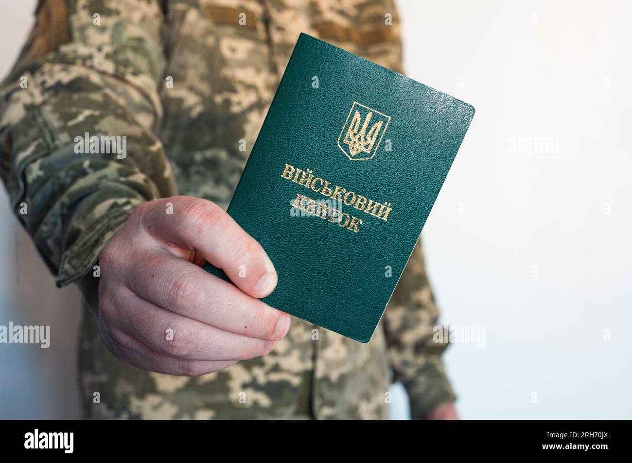 Soldier in camouflage holds military id doc in right hand. Ukrainian ...