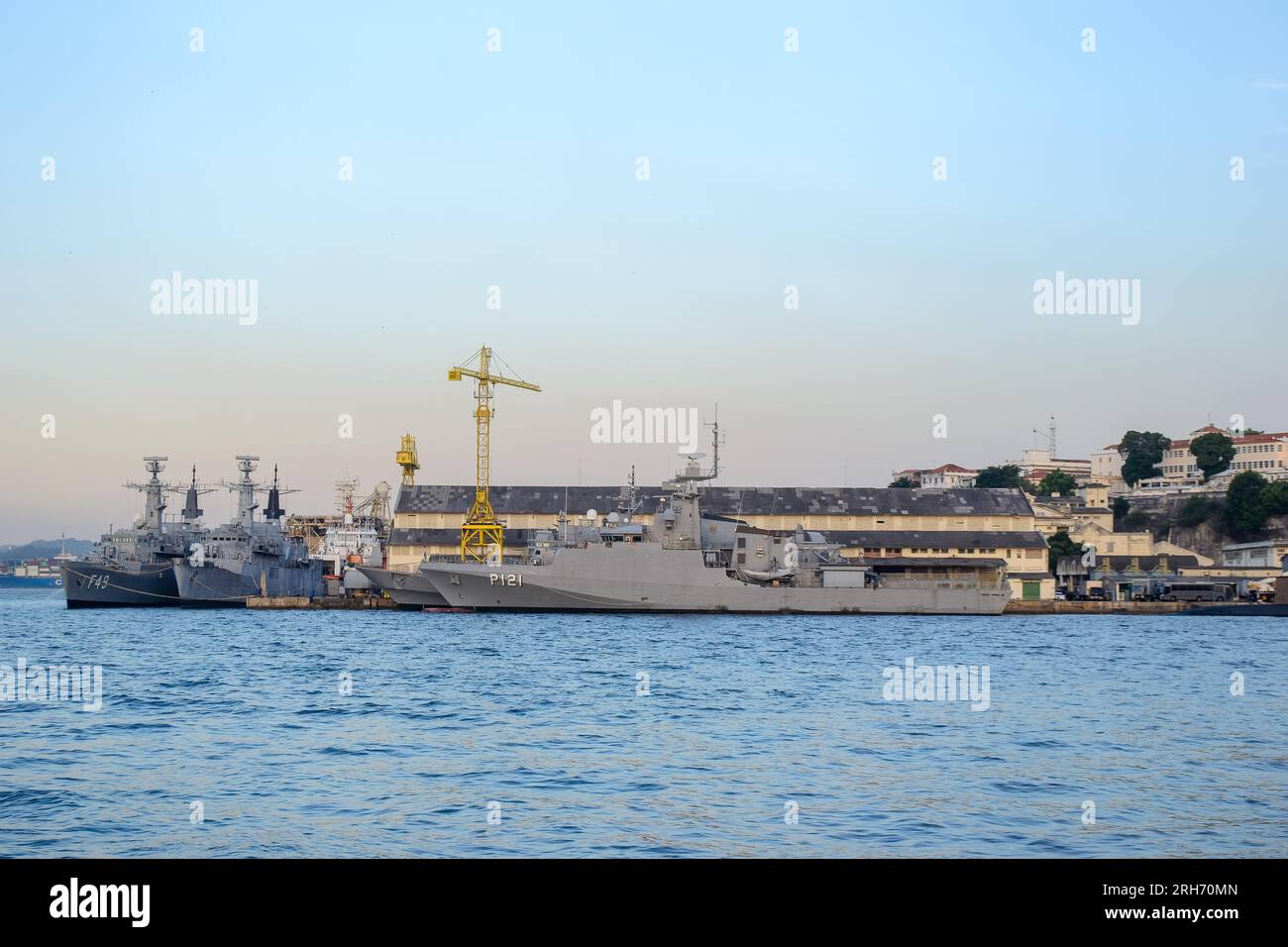 Rio de Janeiro, Brazil, A war ship is moored by a commercial dock with ...