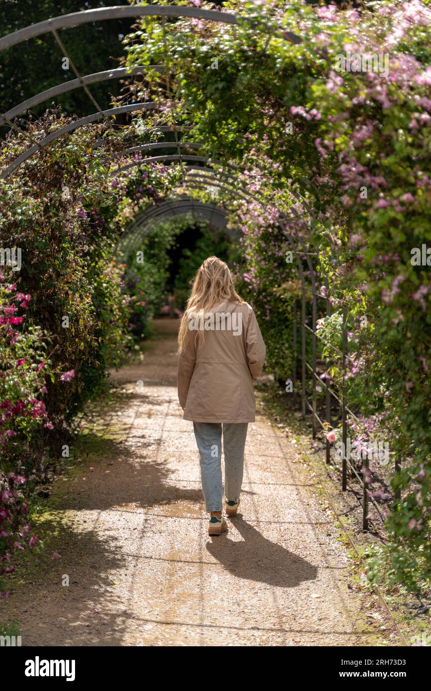 young woman taking a walk through gardens Stock Photo - Alamy