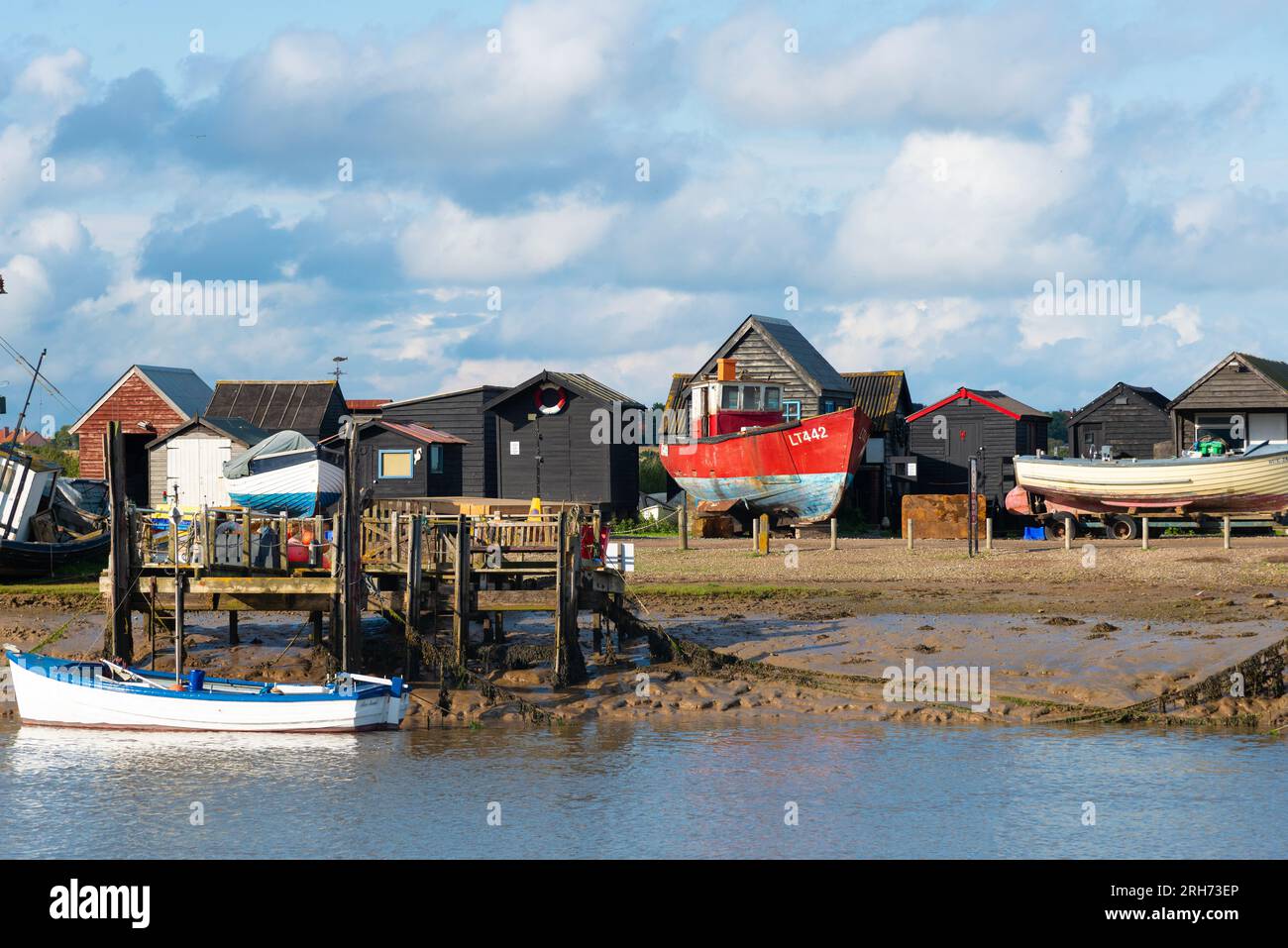 Fishing boats on the bank of the tidal River Blyth near Southwold ...