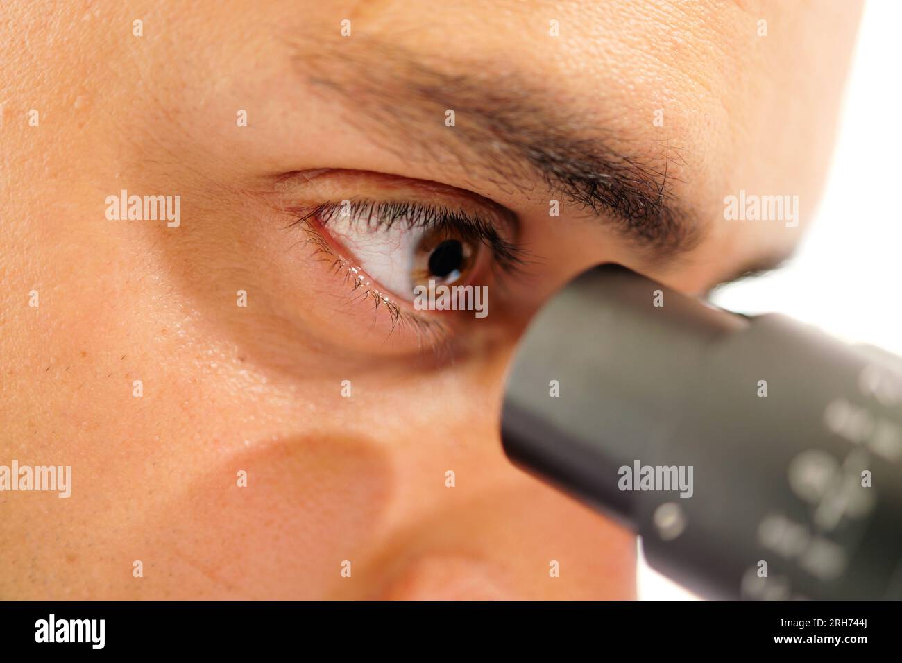 Professional male scientist looking through microscope in laboratory ...