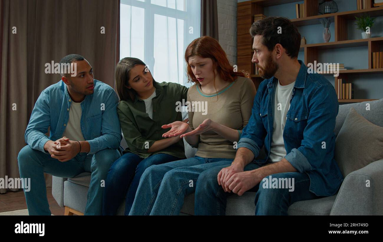 Upset woman cry desperate bullying at home multiethnic team friends support sad anxious girl on ...