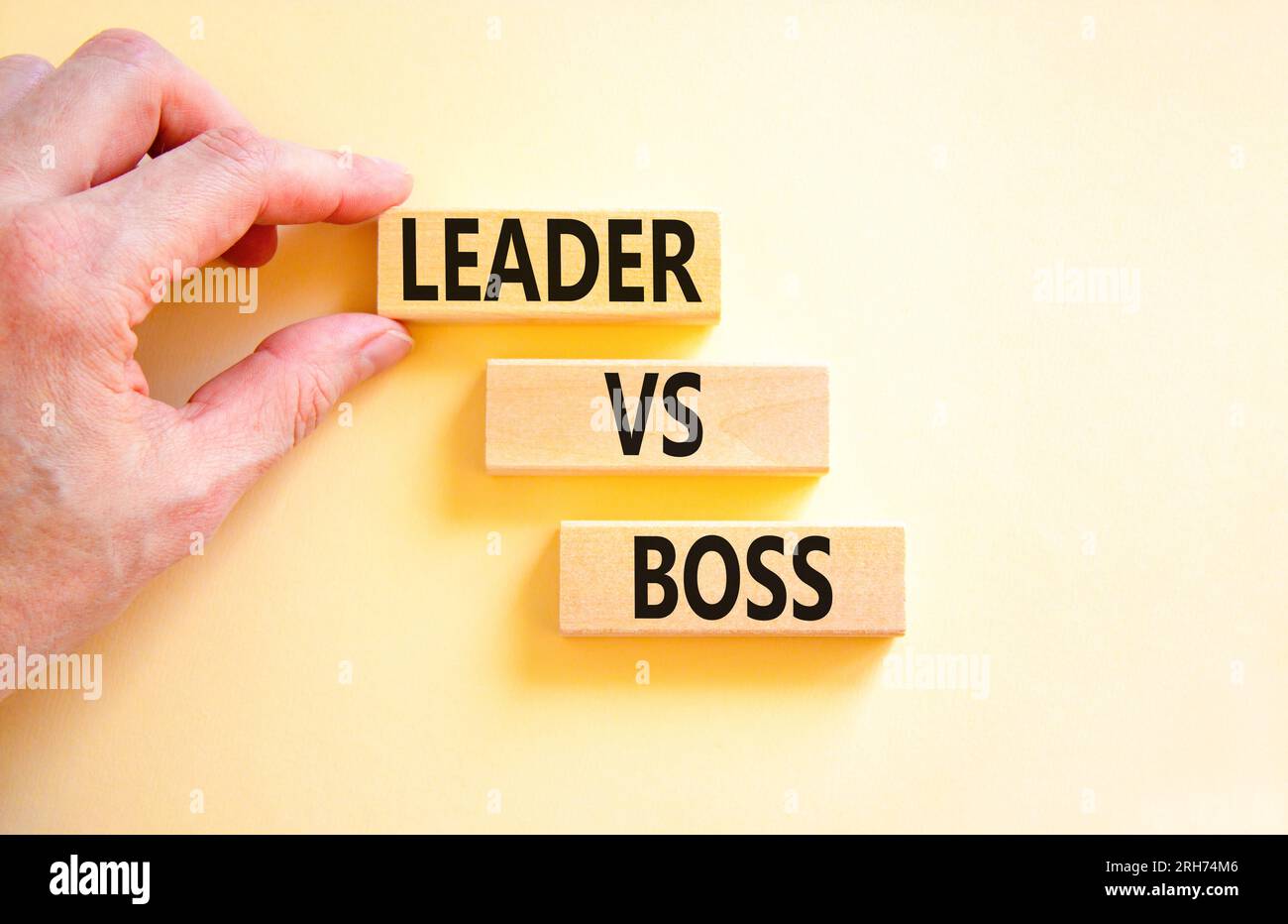 Boss vs leader symbol. Concept words Boss vs versus leader on wooden ...