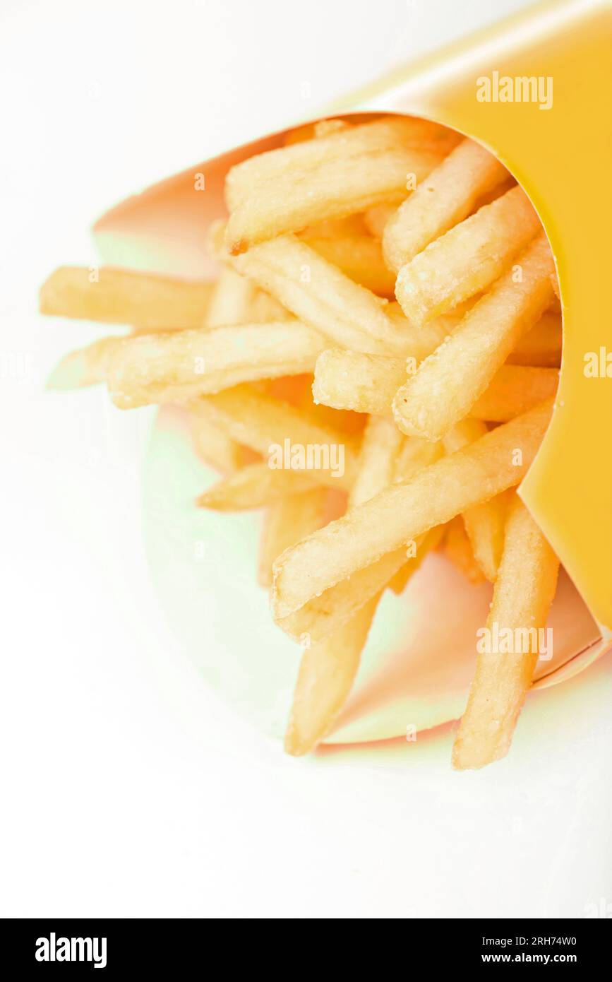 french fries in a paper wrapper on white background Stock Photo - Alamy