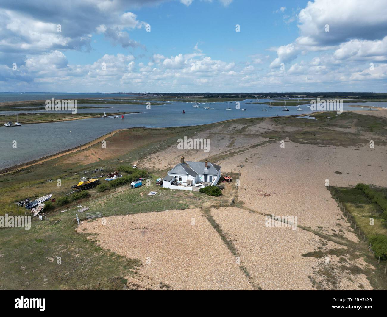 Lone Cottage on shingle beach near Hurst Point lighthouse UK drone ...