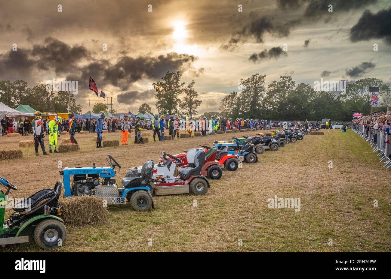 Drivers line up opposite their racing lawn mowers ready for the Le Mans ...