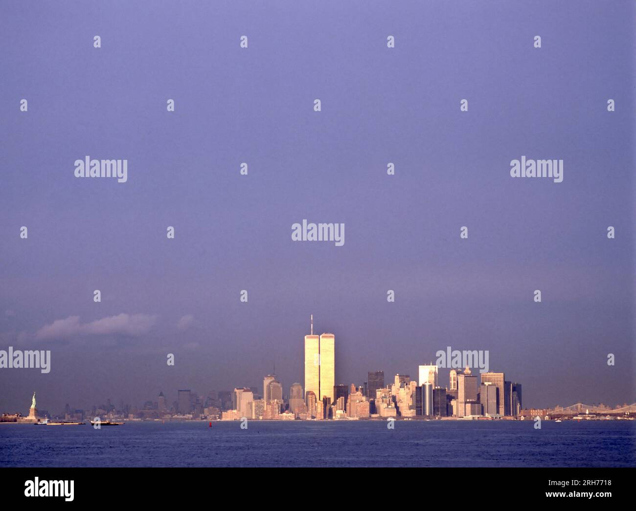 New York City at sunset with the old World Trade Center and the Staue ...