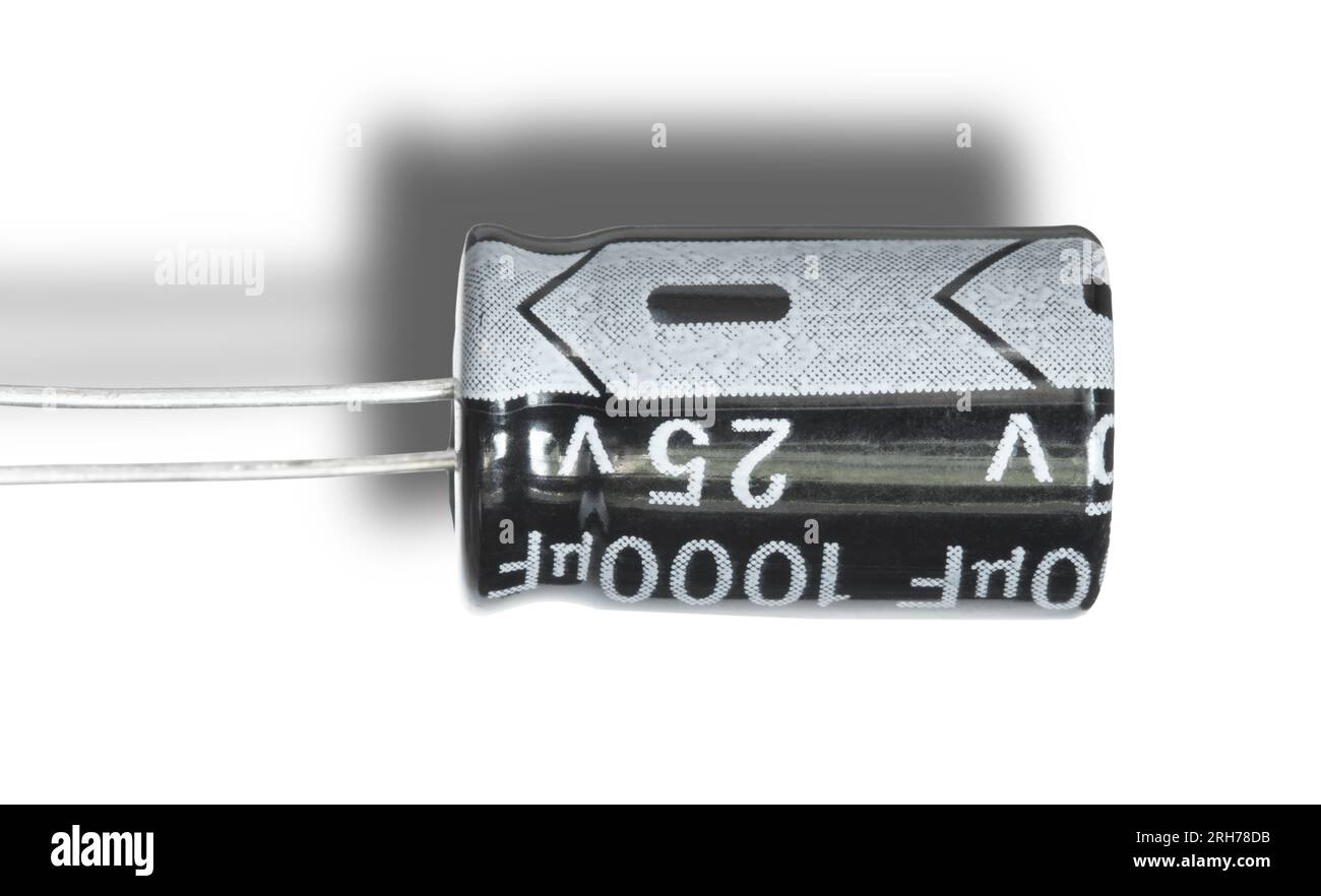 Shadow behind a small capacitor with silver wires used in modern ...