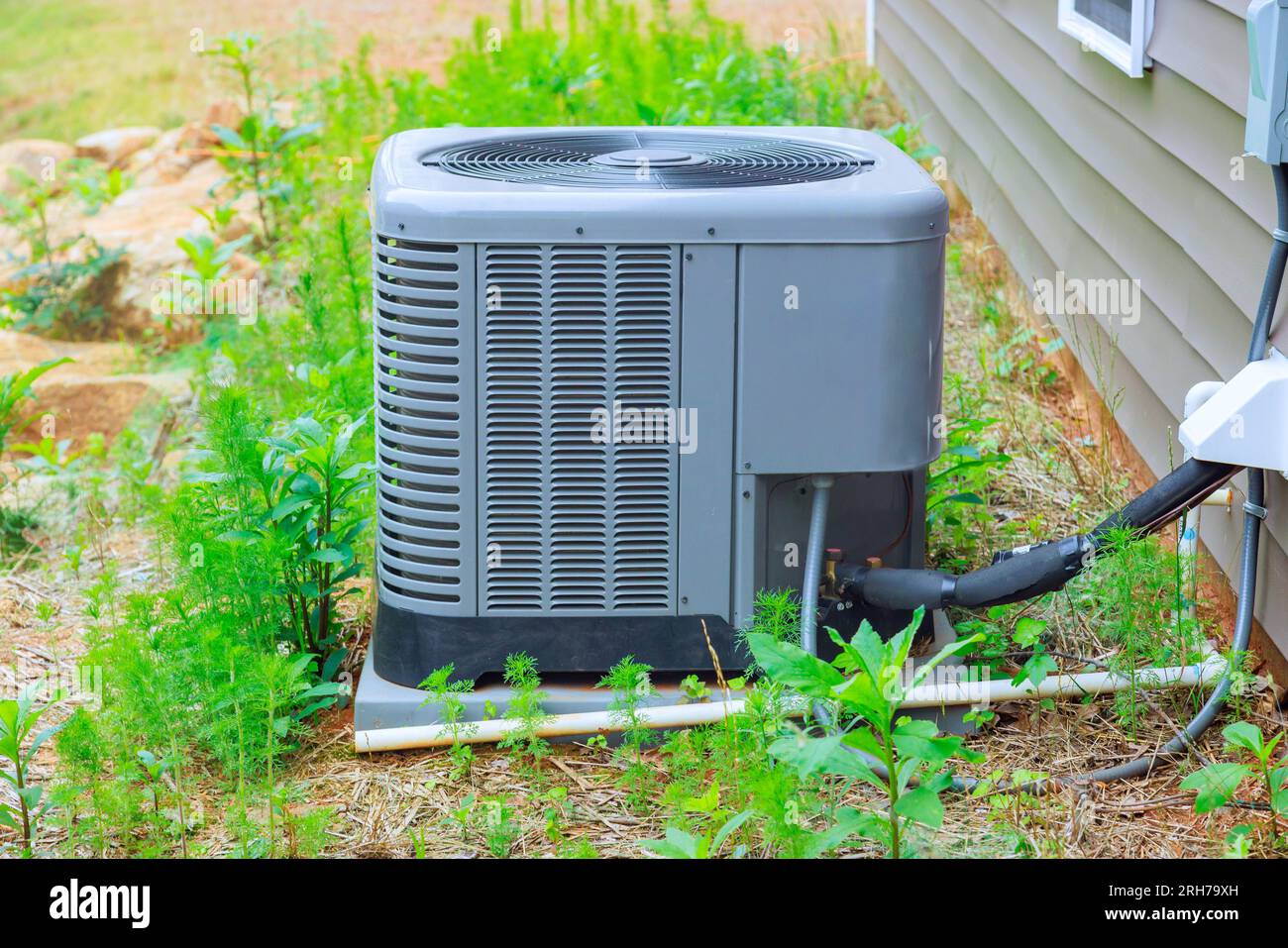 Installed on exterior facade of house is an outdoor air conditioning ...