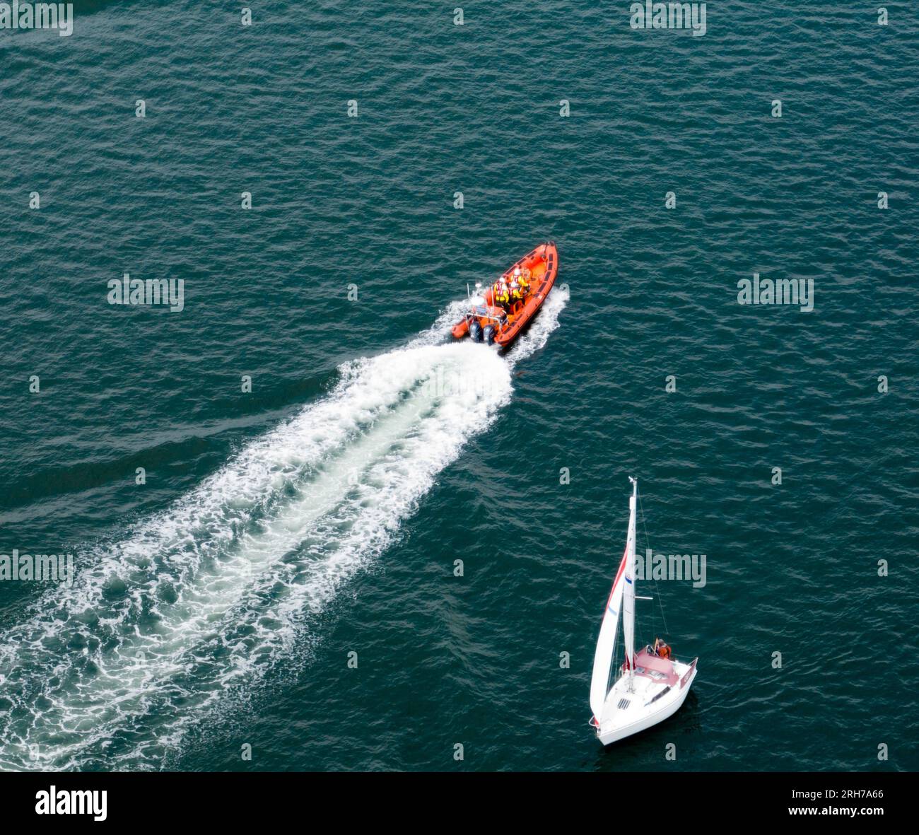 Aerial photograph of a inflatable lifeboat speeding past a small ...