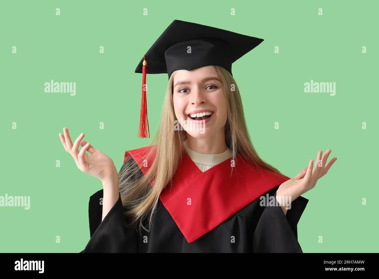 Female graduate student on green background Stock Photo - Alamy