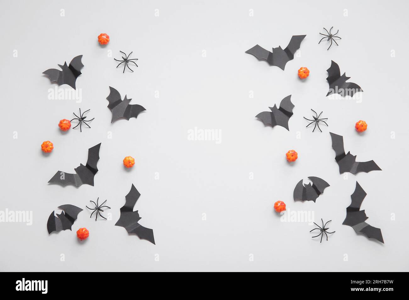 Composition with pumpkins, paper bats and spiders on white background ...