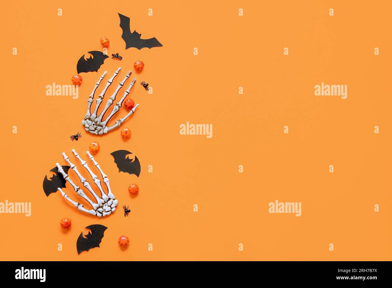 Composition with pumpkins, skeleton hands, paper bats and spiders on ...