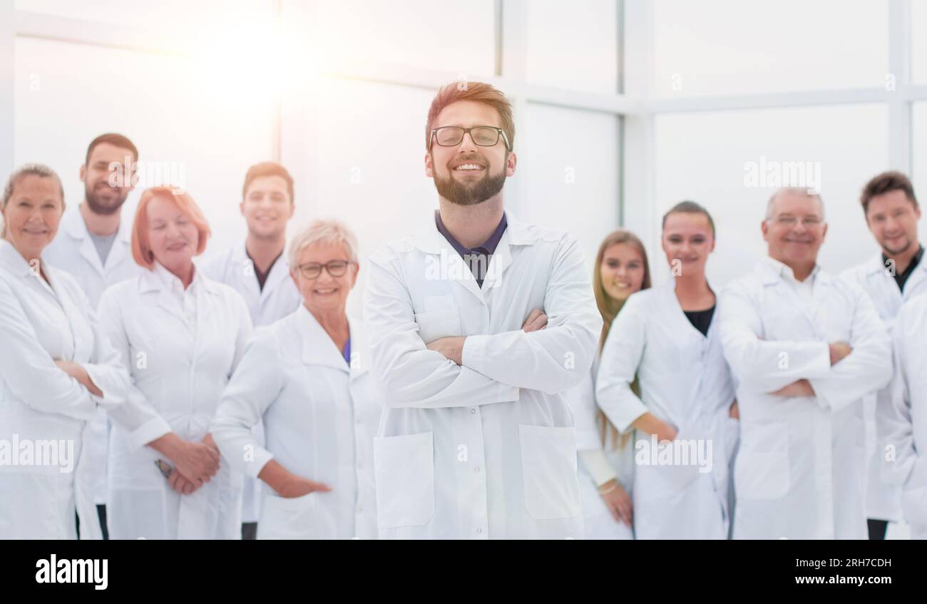 confident scientific leader standing in front of a team of young ...