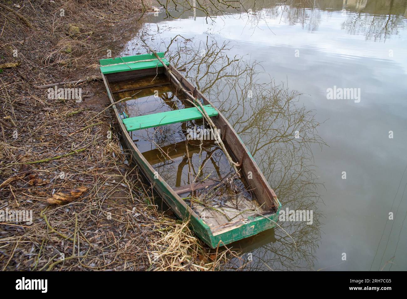Sunken green river boat with reflection of sky and trees Stock Photo ...