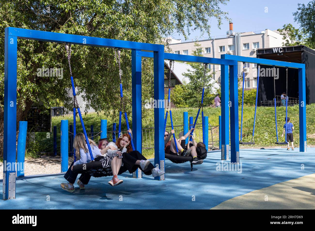 Moscow, Russia - 23 June 2023, Gorky Central Park of Culture and Leisure. Teenagers swing on a ...
