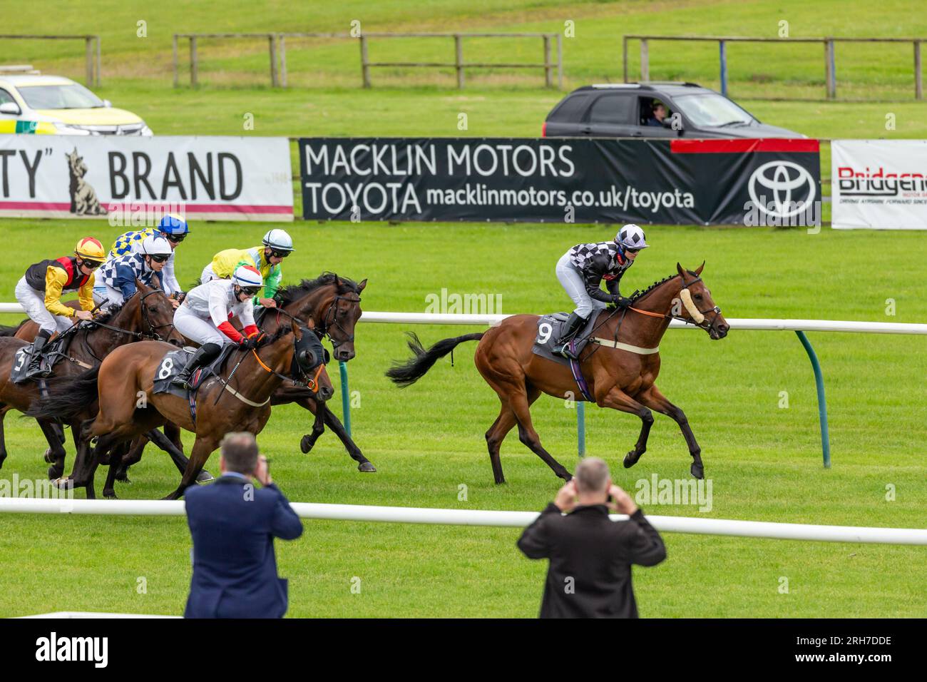 Racehorses running on the grass track at Ayr racecourse, Scotland Stock ...