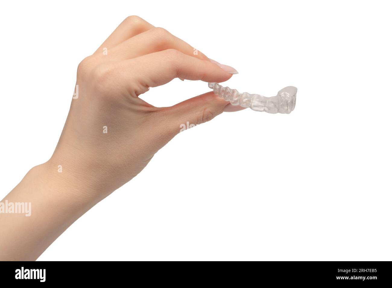 Transparent mouth guard in a woman's hand isolated on a white ...