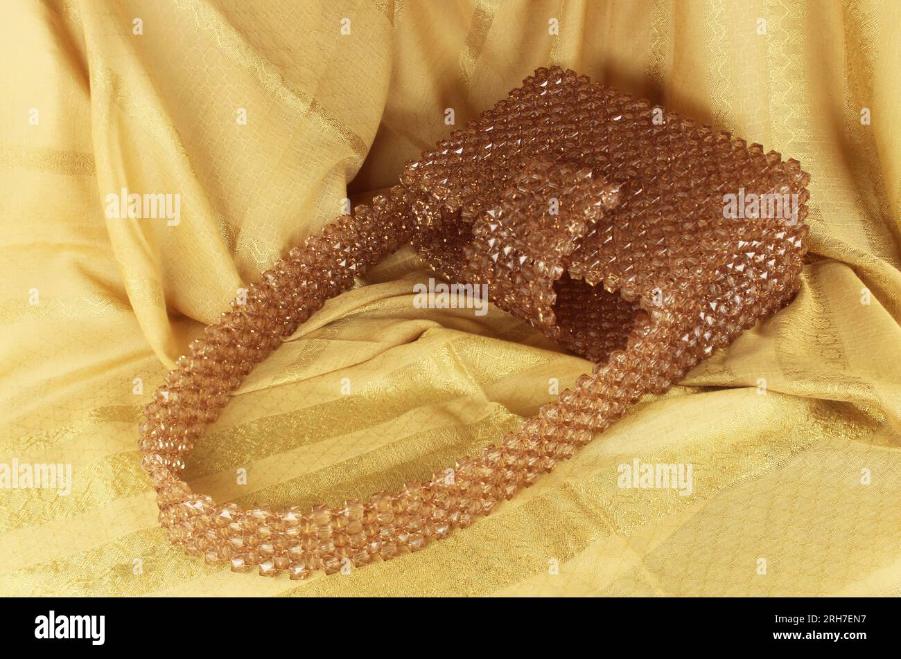 Handmade mink bead bag on yellow fabric Stock Photo - Alamy