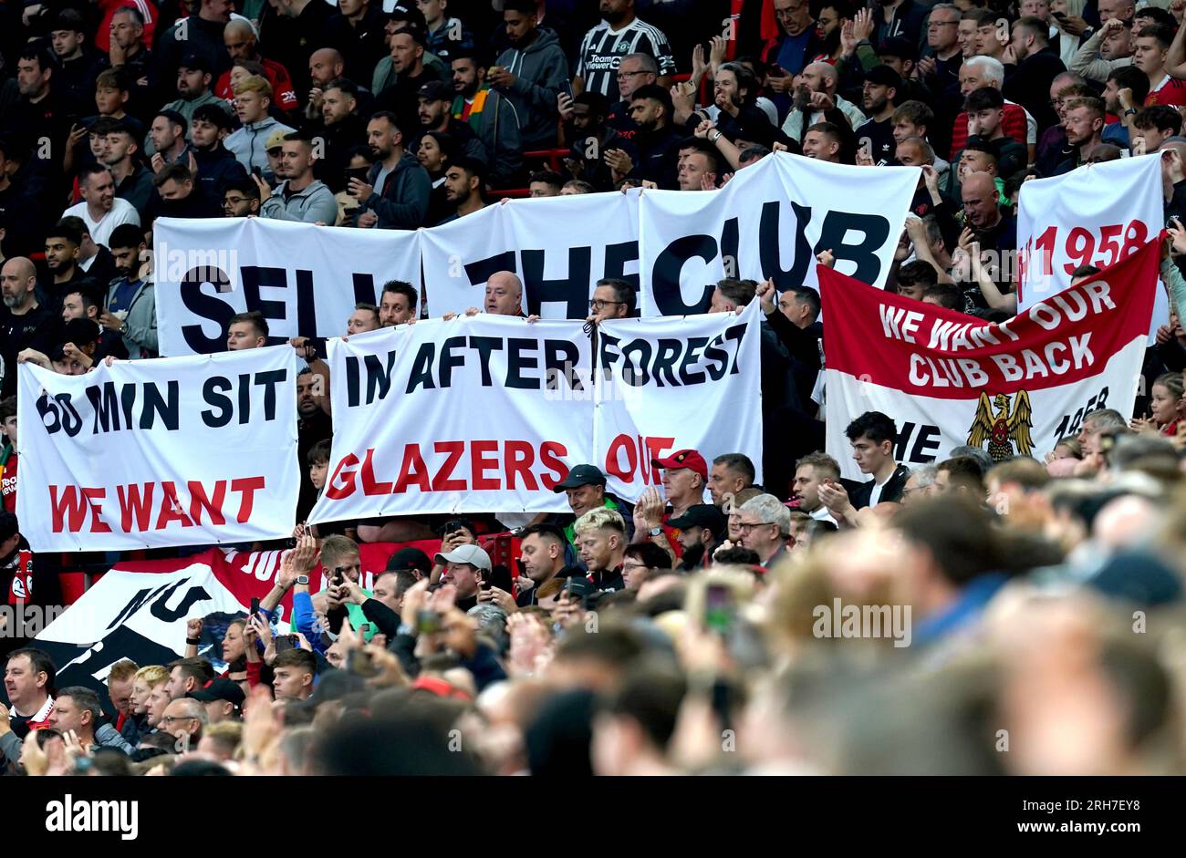 Manchester United fans hold up banners in protest to the owners of the ...
