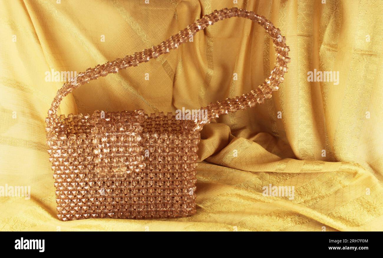 Handmade mink bead bag on yellow fabric Stock Photo - Alamy