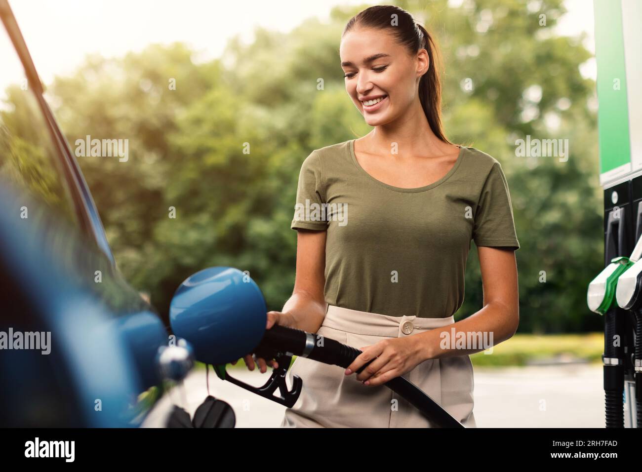 Lady Filling Up Car With Fuel at Modern Gas Station Stock Photo - Alamy
