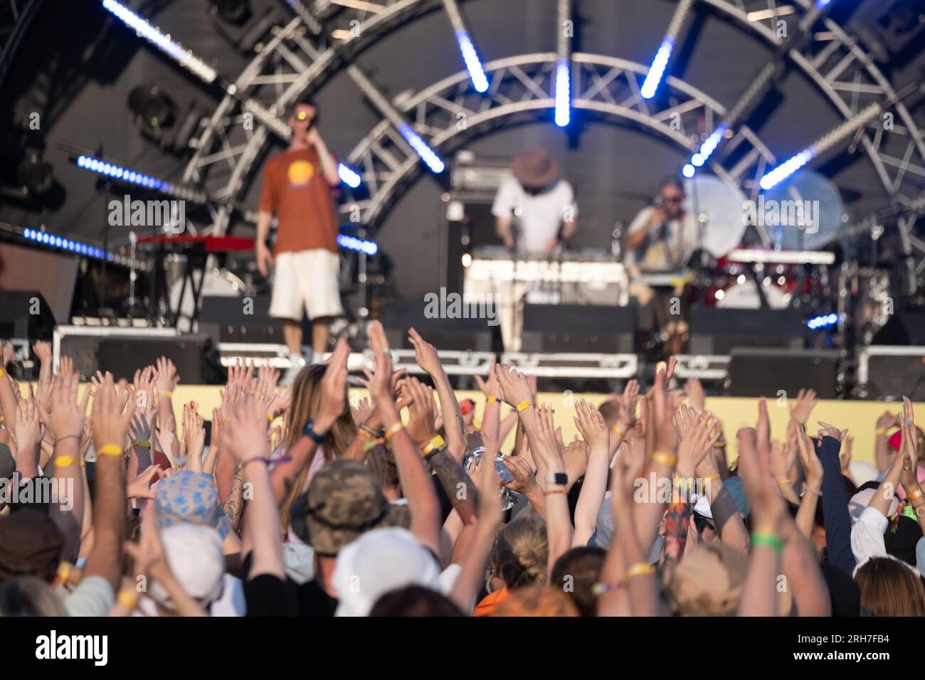 Raised arms of people greeting music band on stage and enjoying live ...