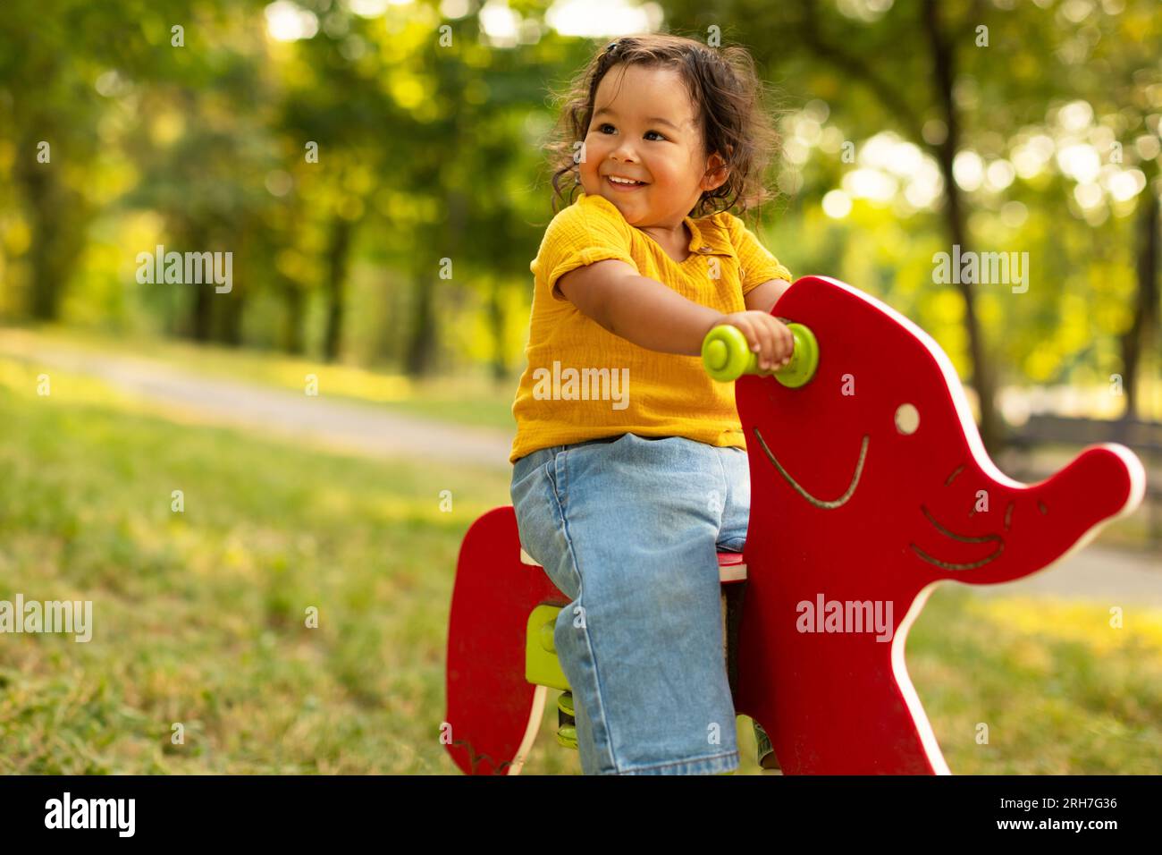 Cheerful Japanese Baby Girl Riding Coil Spring Elephant at Playground ...