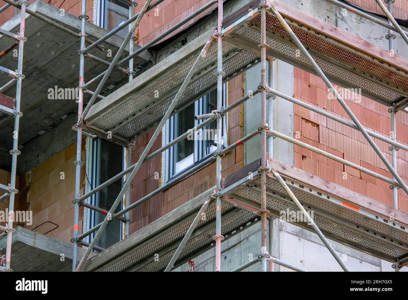 Reconstruction of red brick block of houses with metal scaffolding ...