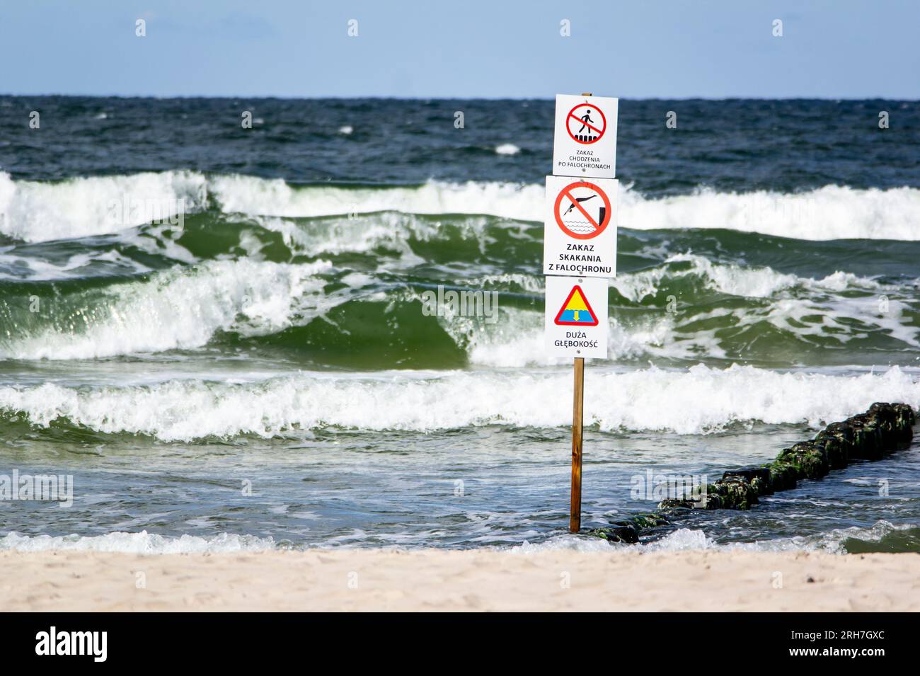 Warning sign forbidding jumping from breakwater structure because it is ...