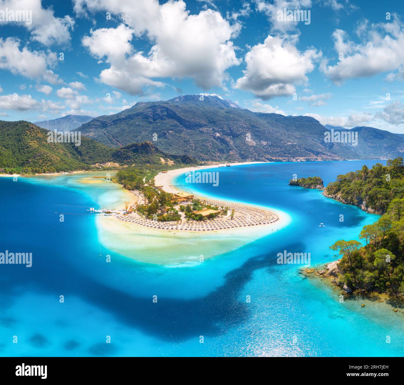 Aerial view of sea bay, sandy beach, green trees, mountain Stock Photo ...