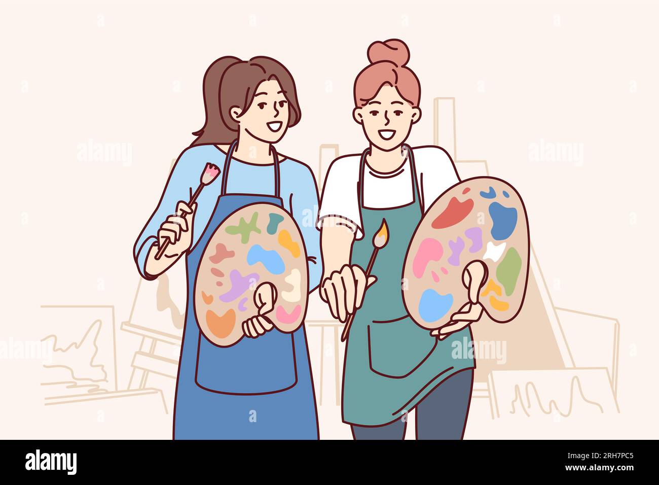 Two women artists hold brushes and palettes standing in workshop with ...