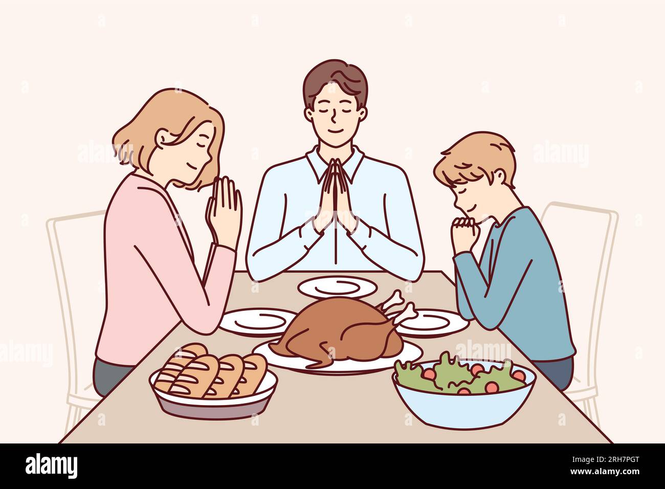 Family prayer before dinner, sitting at table with delicious food and ...