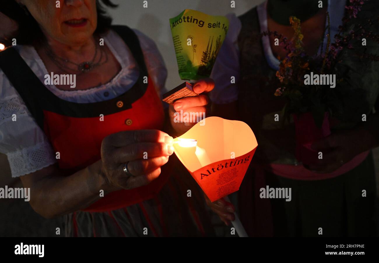 14 August 2023, Bavaria, Altötting: The faithful light their candles ...