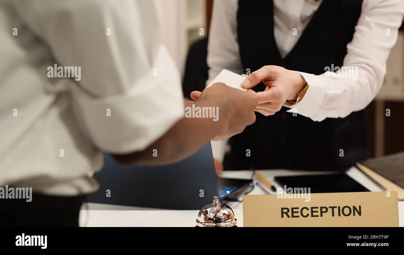 Handing key card hi-res stock photography and images - Alamy