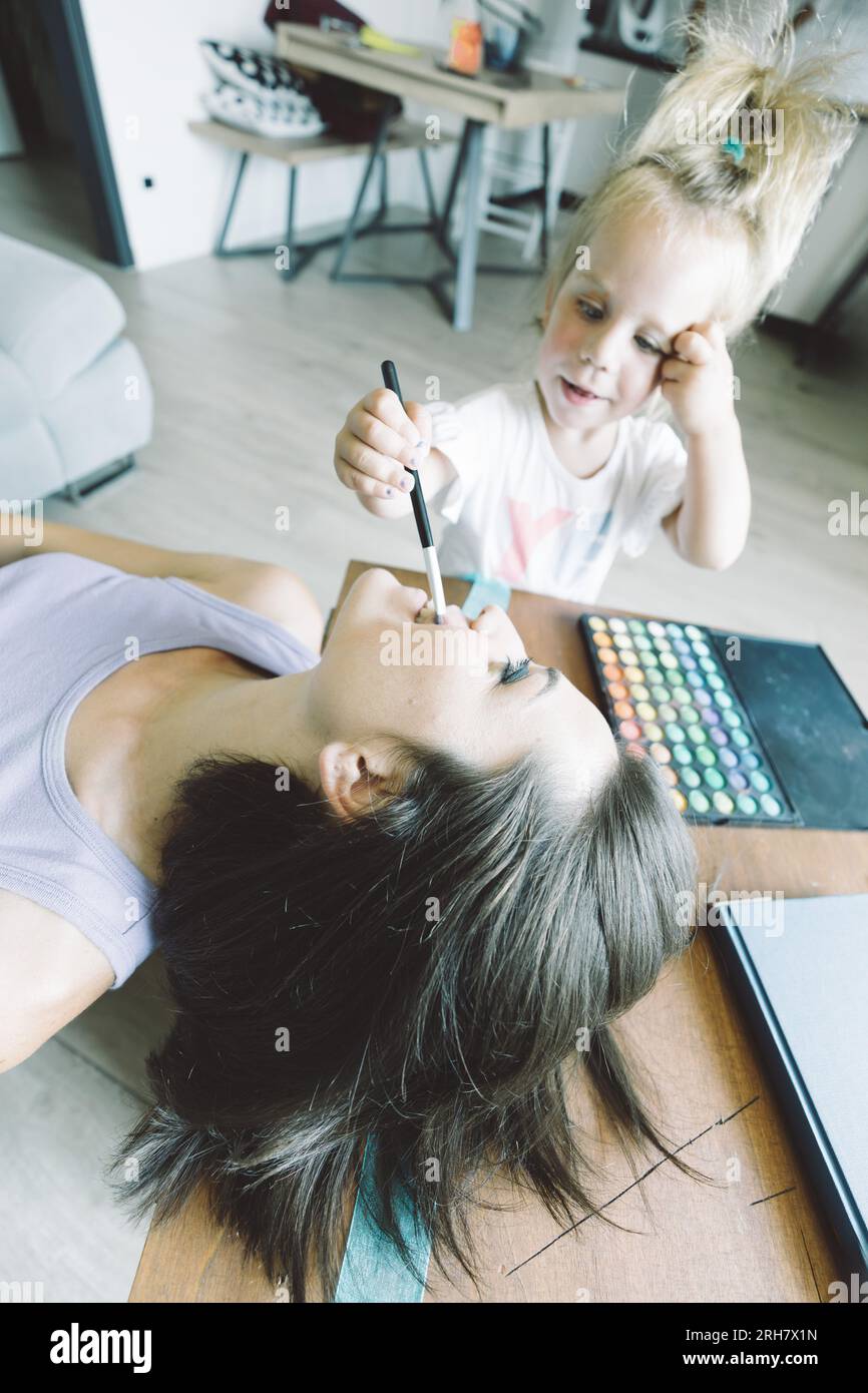 Mother and child play in the living room, turning into princesses with ...