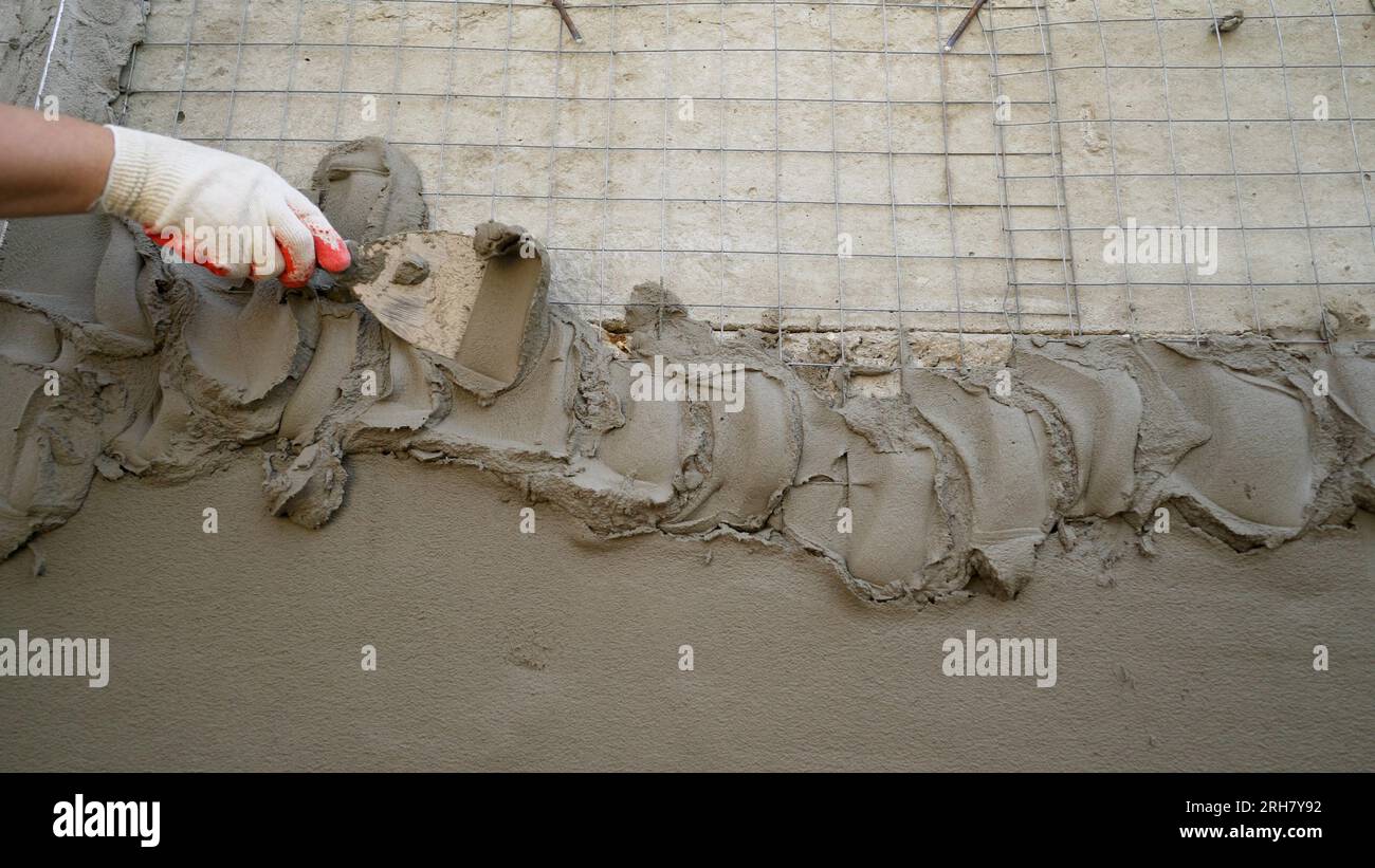 Cement fixing mesh attached to a rough cement wall. Application of ...