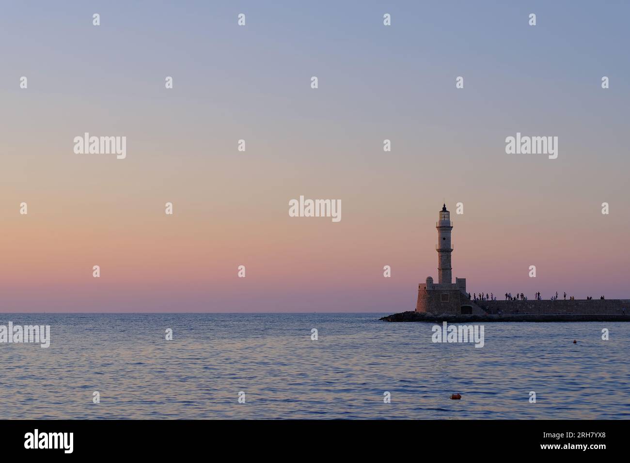 Chania lighthouse landmark silhouette in a beautiful coastal sunset ...