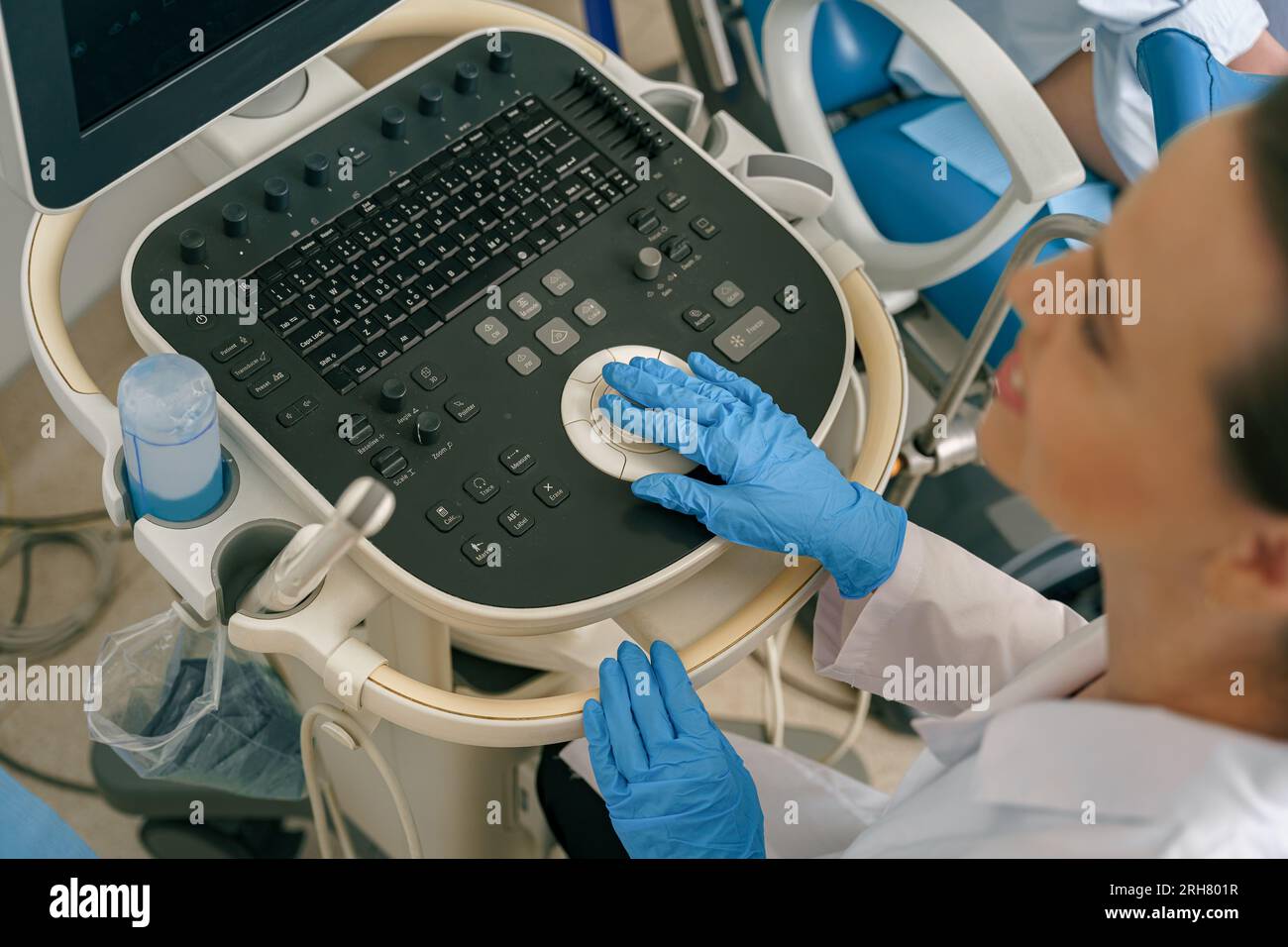Female professional doctor sonographer pushing buttons on ultrasound ...