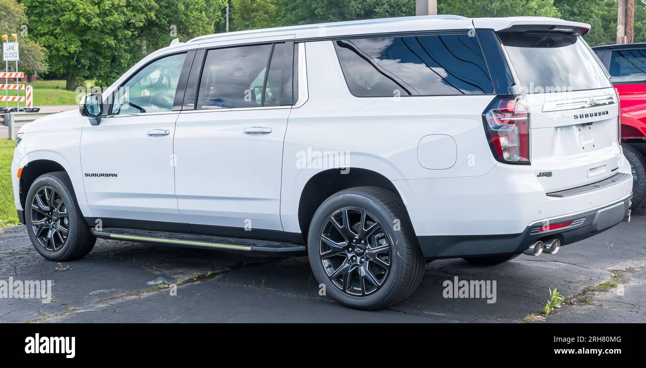 A new, white Chevrolet Suburban SUV for sale at a dealership in ...