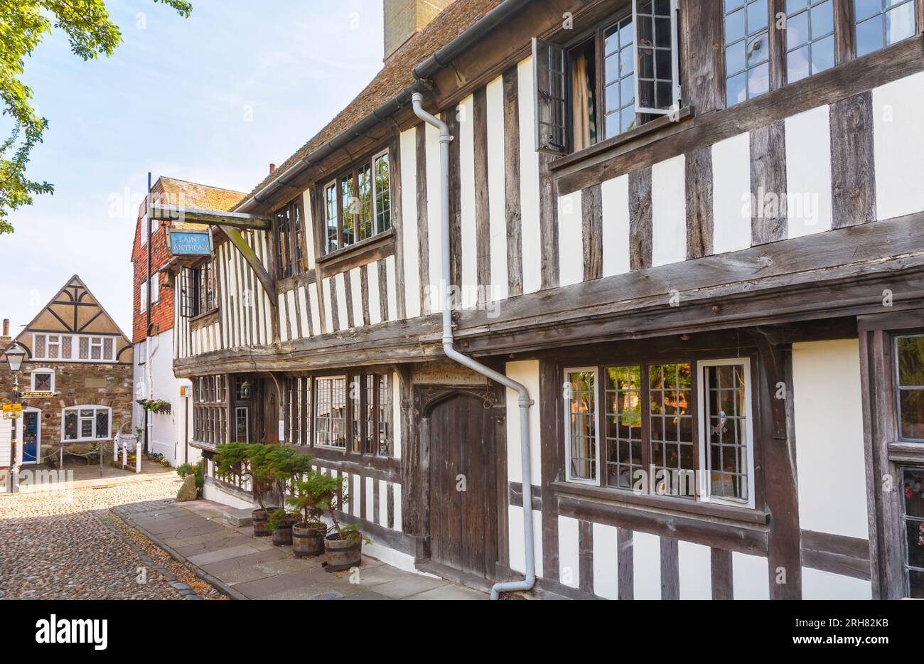 Traditional black and white timbered medieval cottages in a cobbled ...