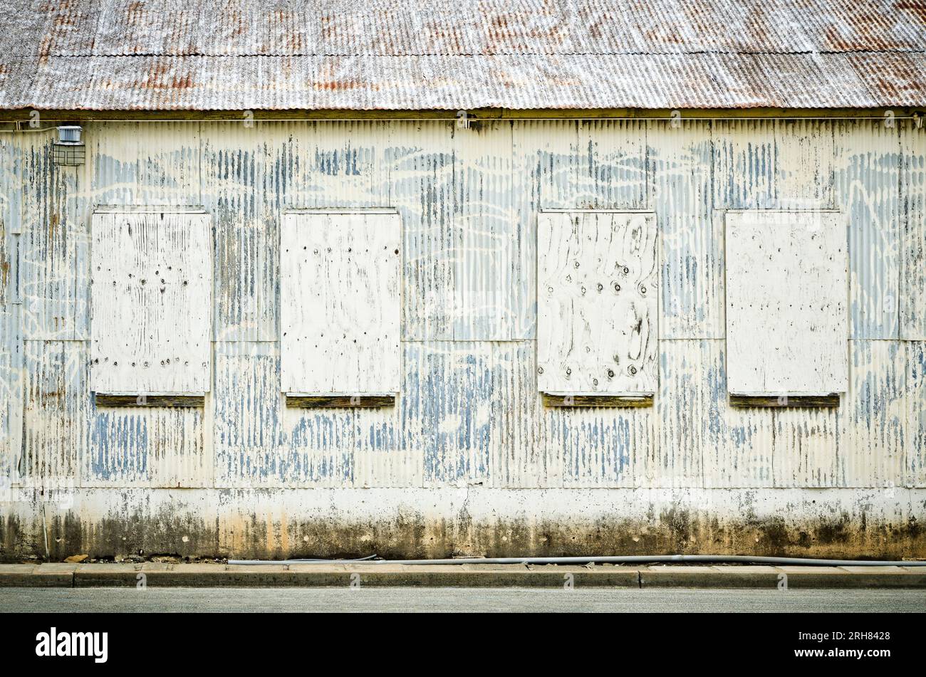 Shuttered windows on the side of an abandoned warehouse in the former ...