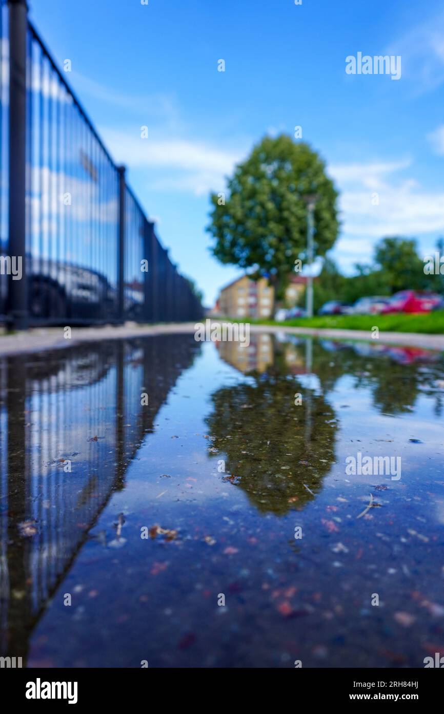 Close up of a puddle on walkway Stock Photo - Alamy