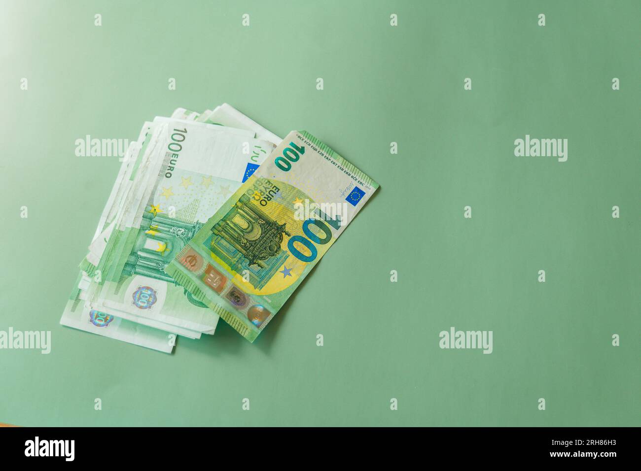 European Union money. One hundred euro banknotes on a green background ...